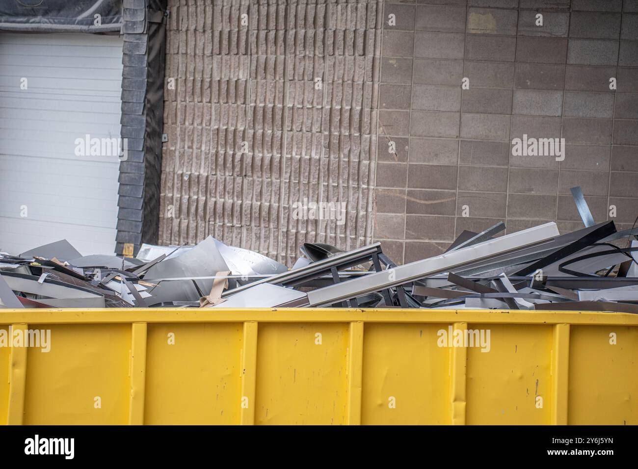 scrap metal steel in yellow recycle container Stock Photo - Alamy