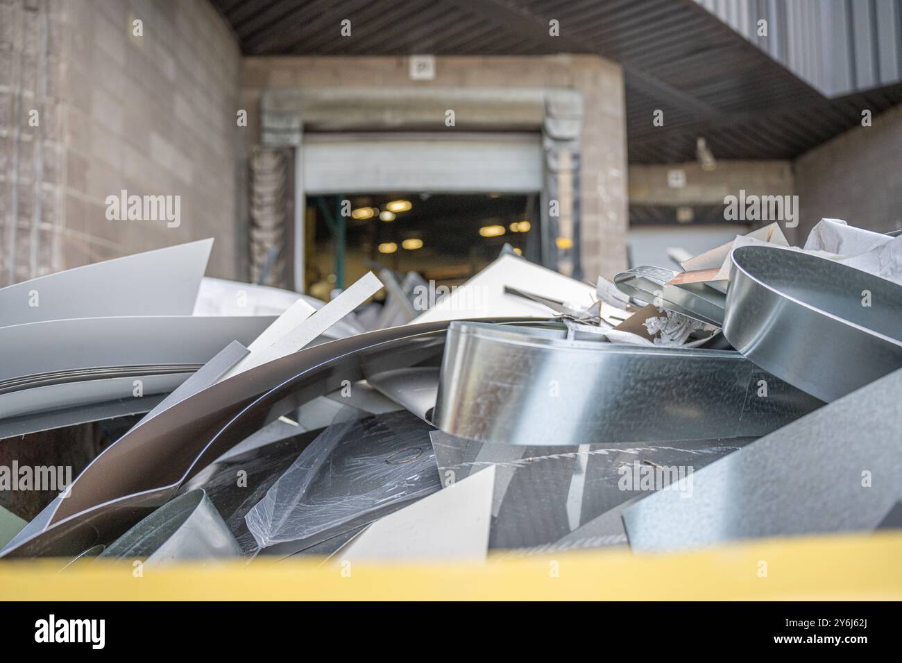 scrap metal steel in yellow recycle container Stock Photo - Alamy