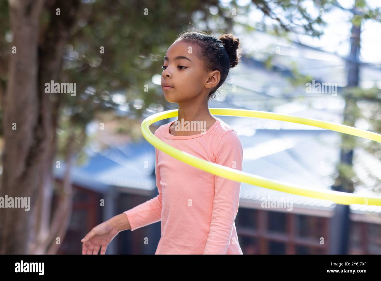 Hula hooping, african american girl enjoying outdoor activity at school ...