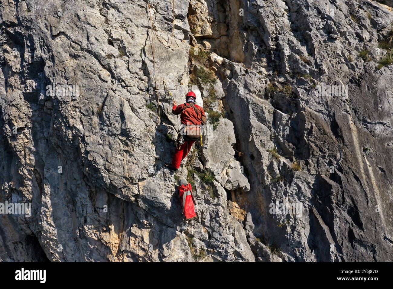 Aerial view of mountain rescuer doing rescue operations hanging on a ...
