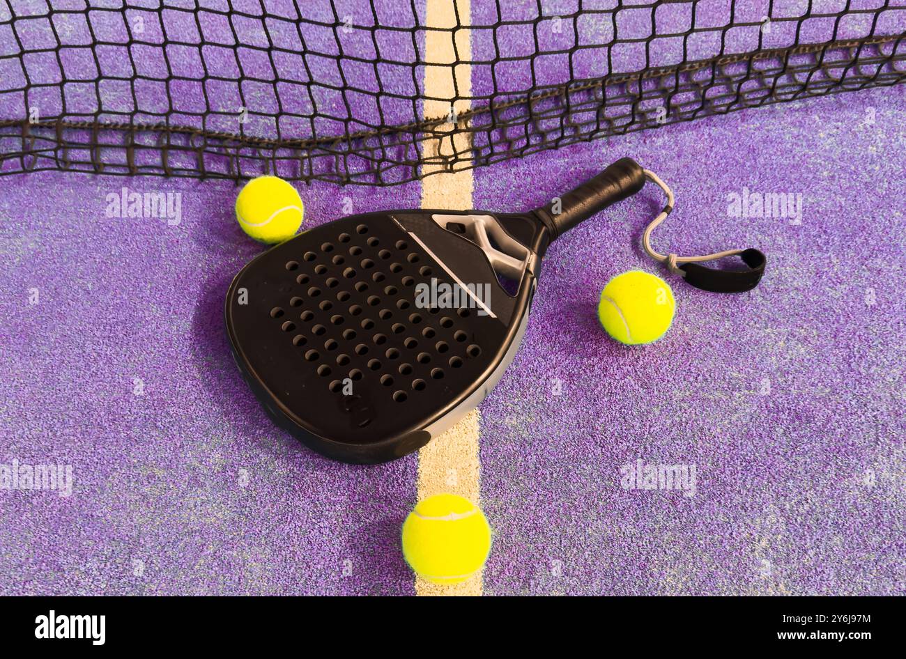 Paddle racket with a ball. Padel court in summer Stock Photo - Alamy