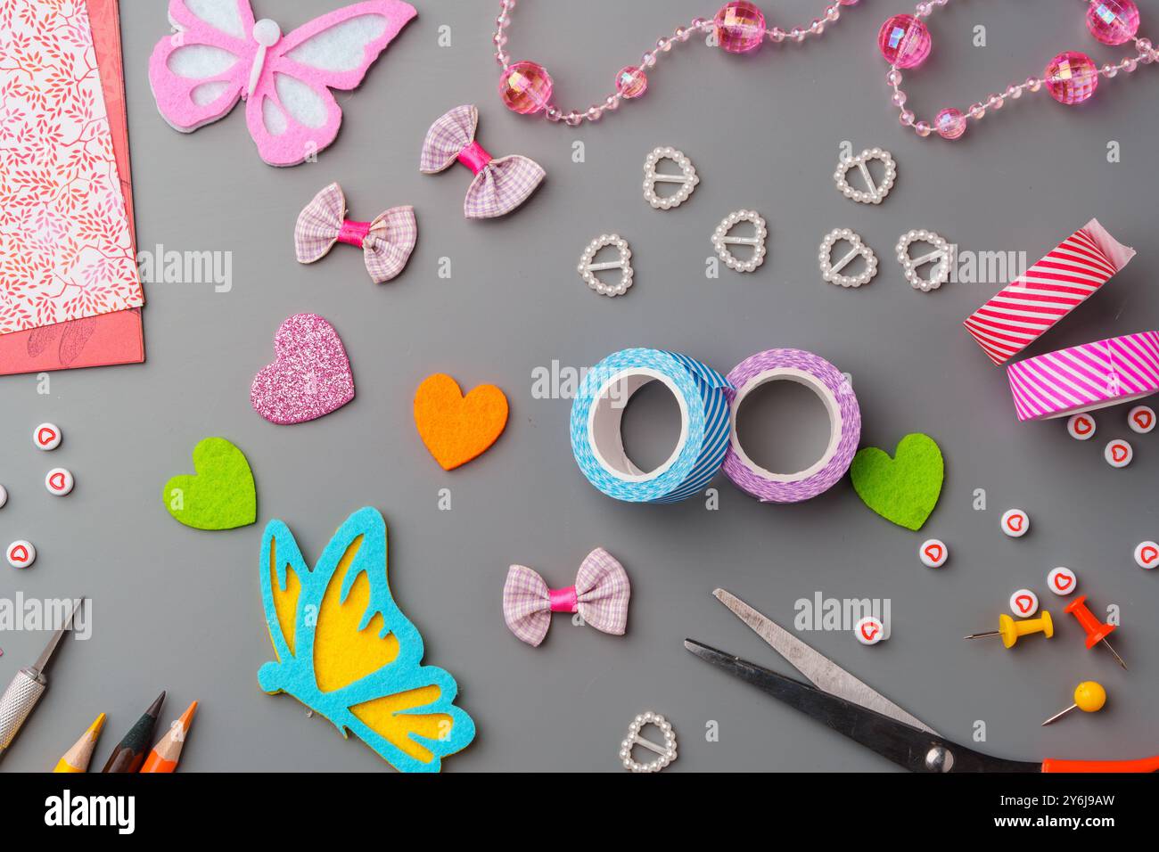 Crafting materials and tools arranged on a gray surface during a ...