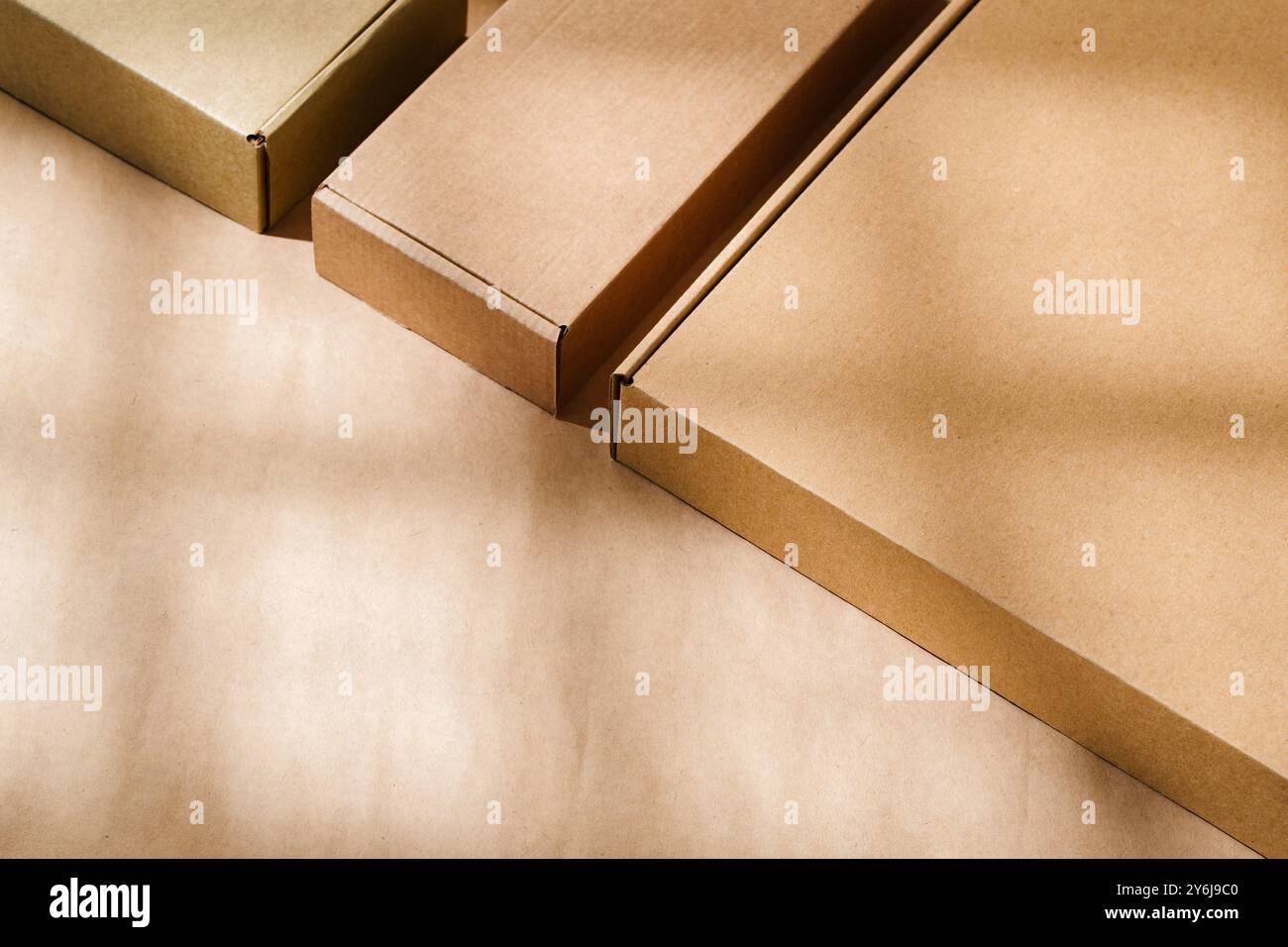 Brown cardboard boxes arranged on a neutral background in a warehouse ...