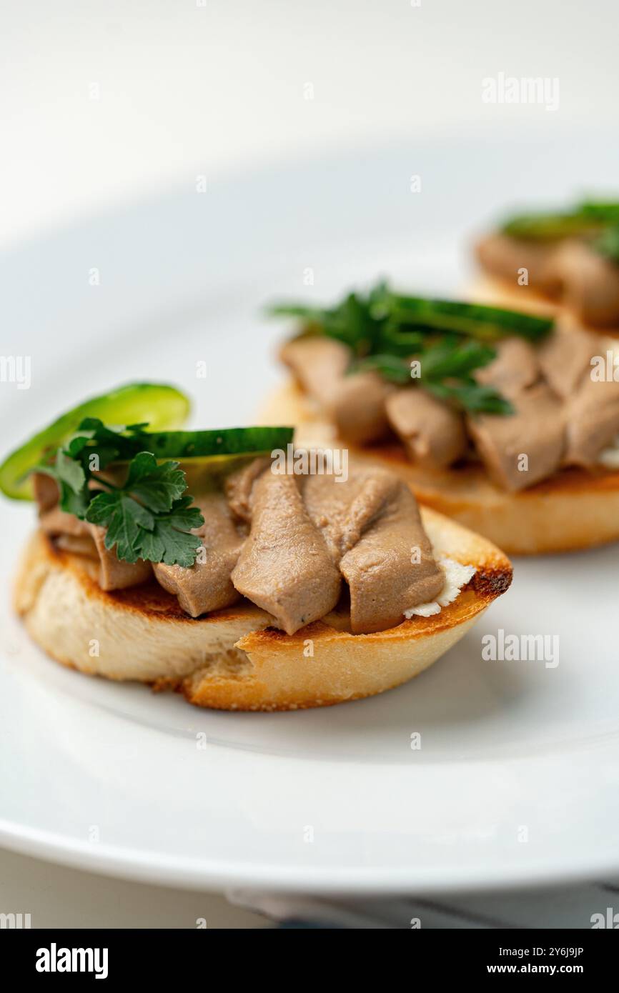 Savory canapes topped with creamy spread and cucumber slices served on ...