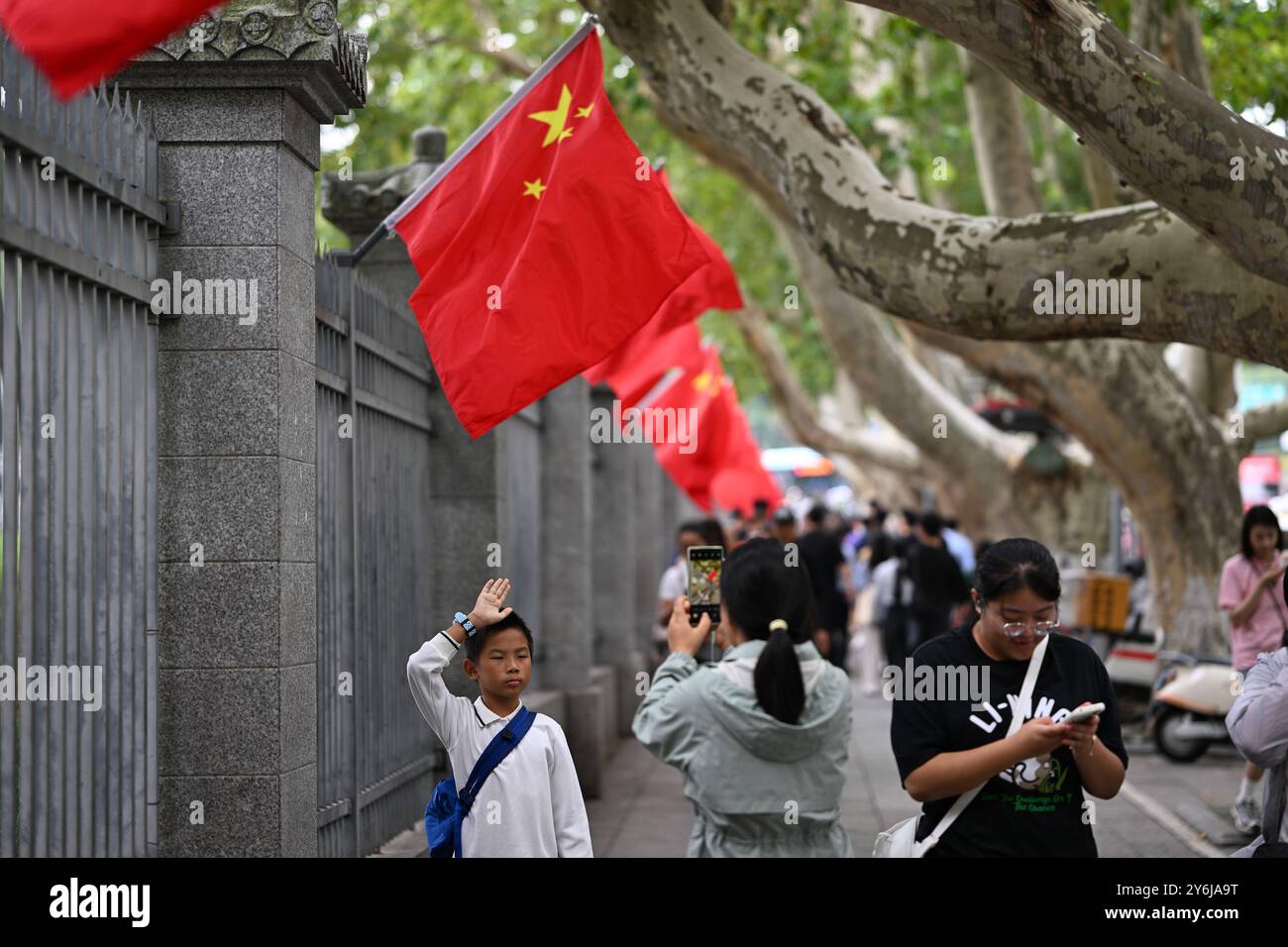 NANJING, CHINA - SEPTEMBER 26, 2024 - National flags are displayed on a ...