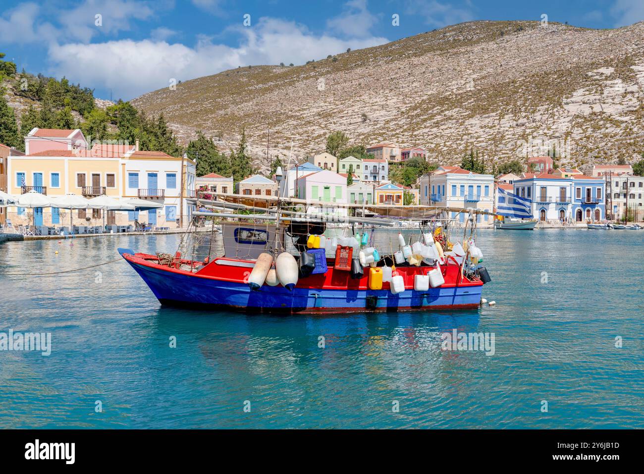 A boat with many fenders and many empty plastic used as fender and ...