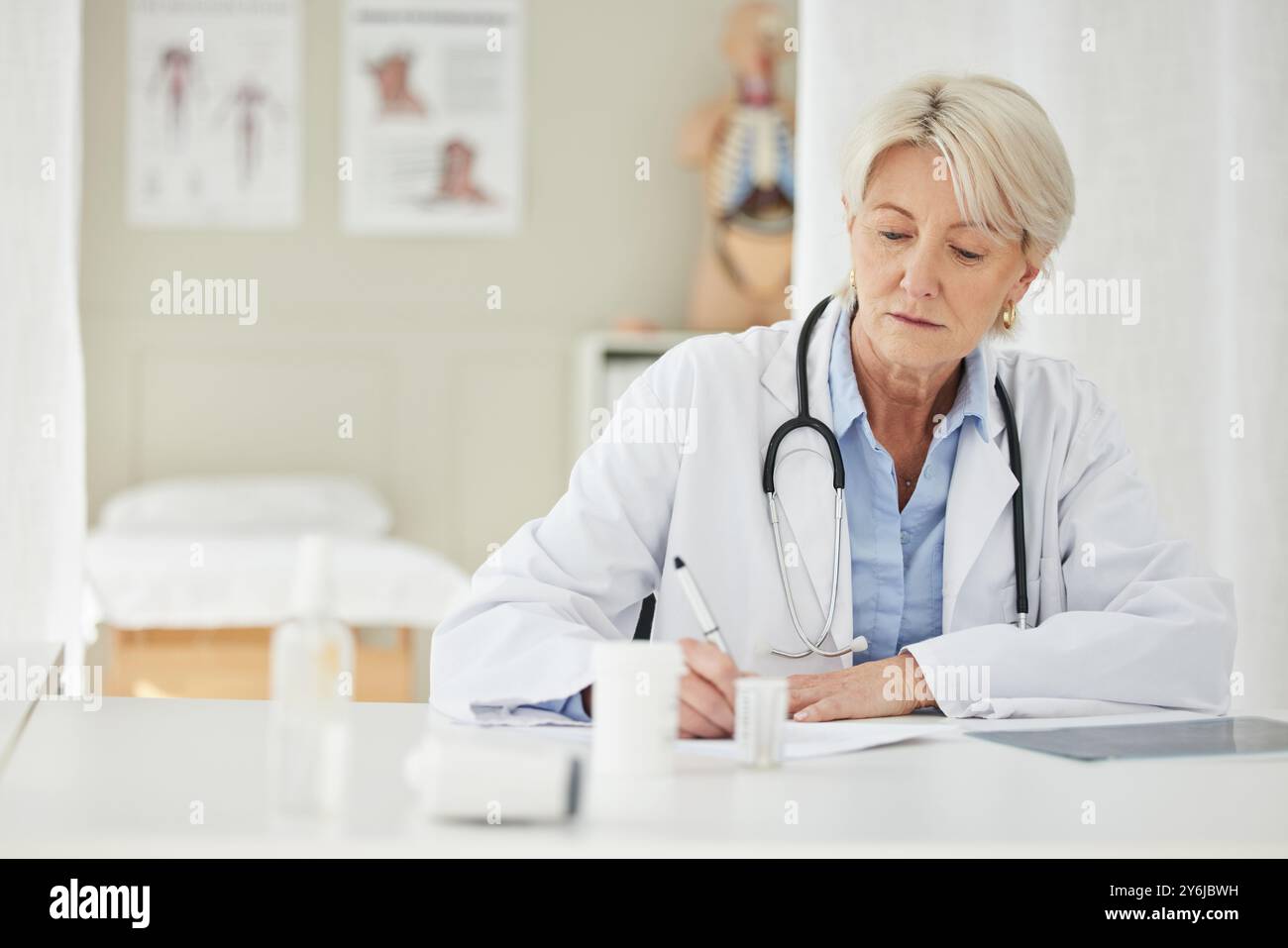 Mature, woman and doctor writing on documents for patient records ...