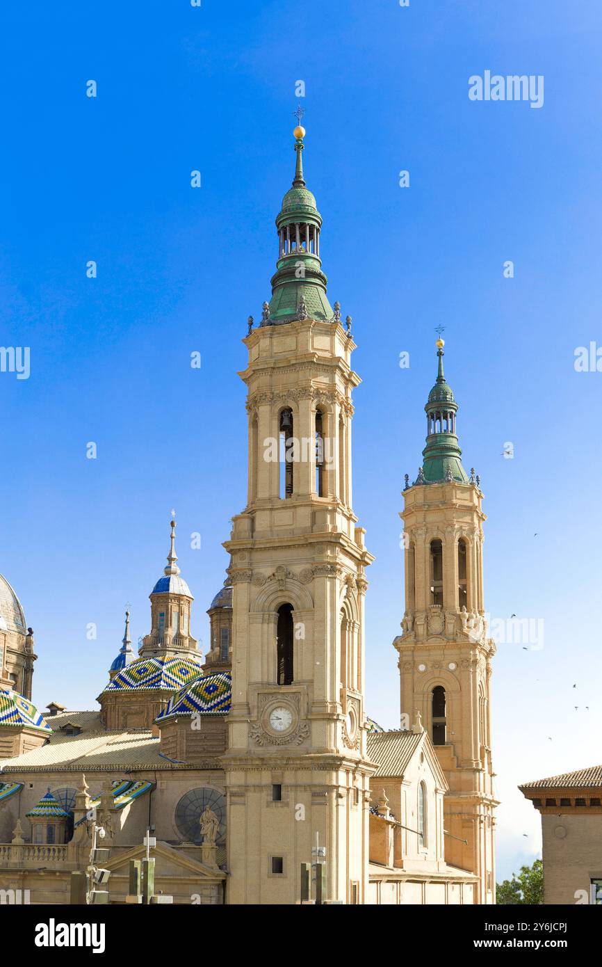 A large, ornate building with two tall towers and a clock on the front ...
