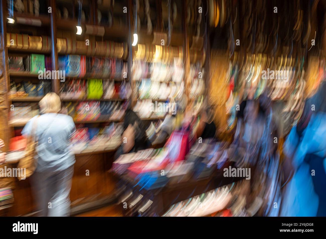 People browse through a vibrant bookstore lined with shelves of diverse ...