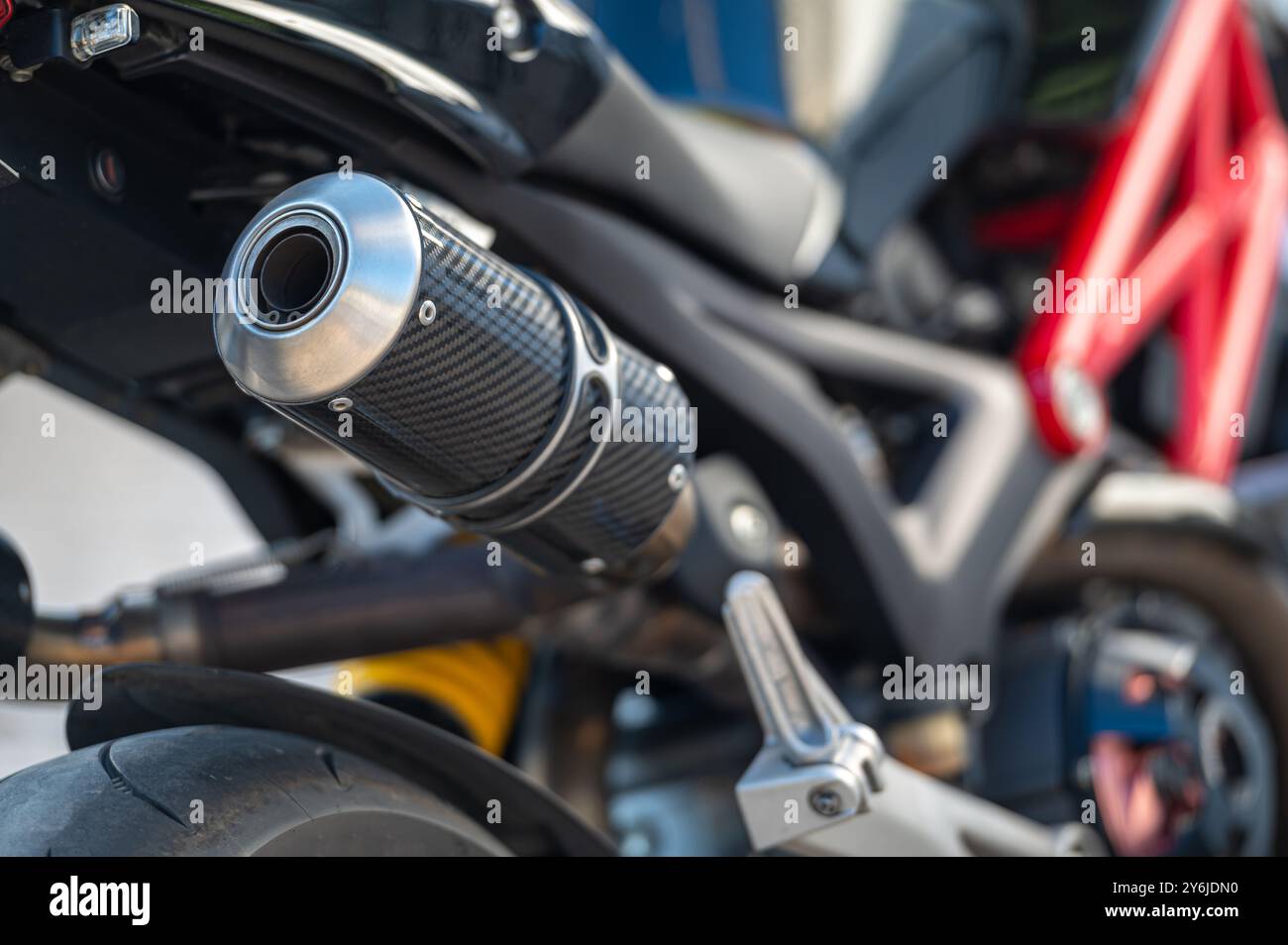 A detailed view showcasing the exhaust system of a motorcycle, focusing ...
