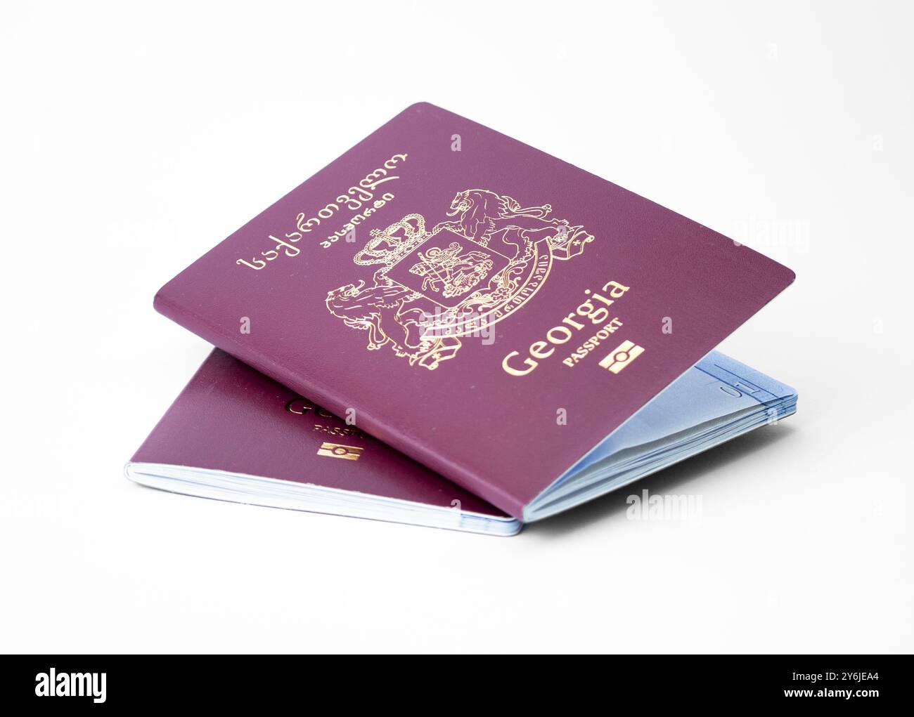 The image showcases two Georgian passports prominently featuring the ...
