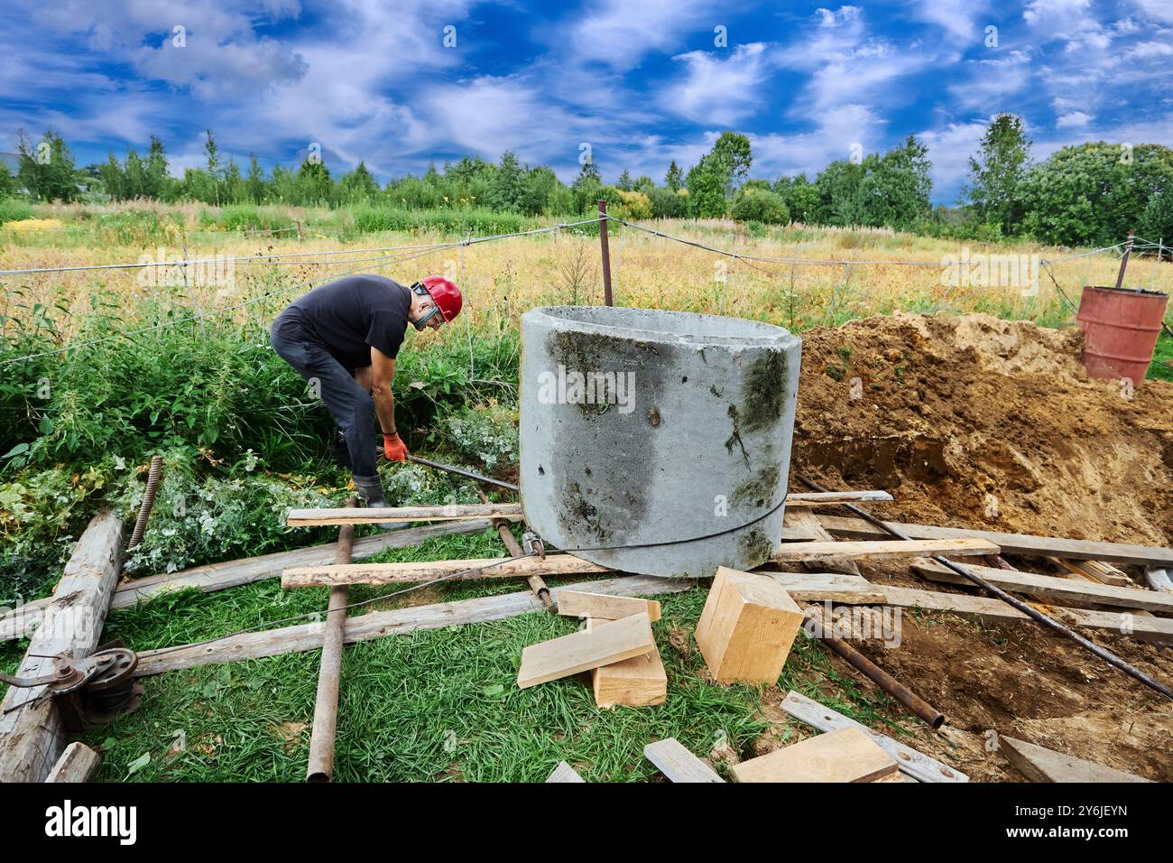 Rigger uses roller bed system and crowbar as lever to move concrete ...