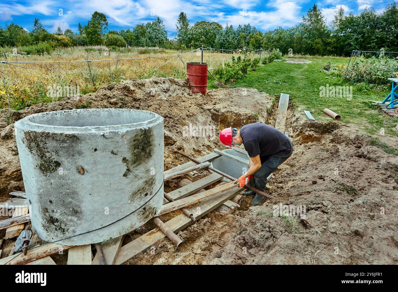 Using roller deck to move concrete ring during installation of septic ...