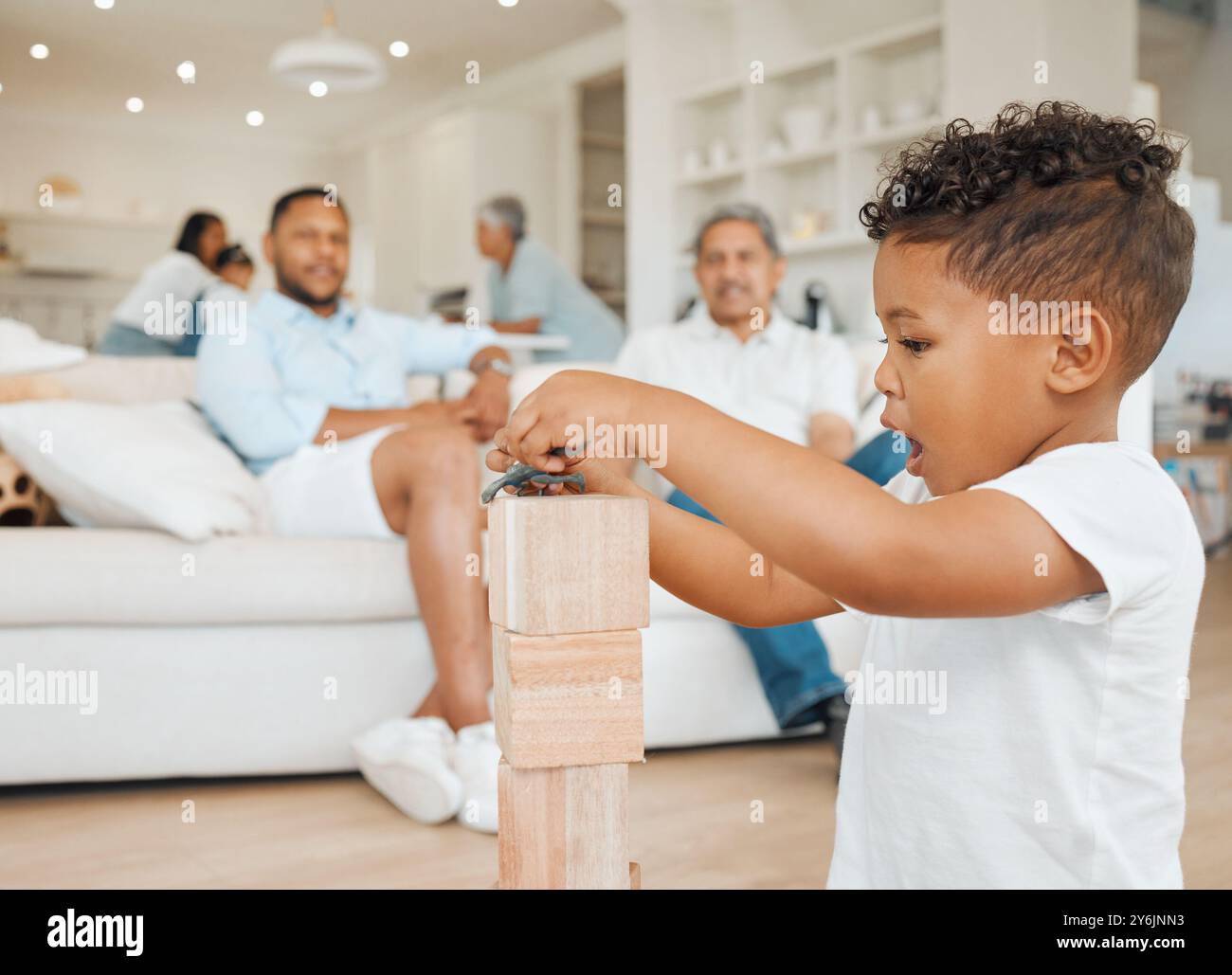 Home, child and playful with wooden blocks for building, game and ...