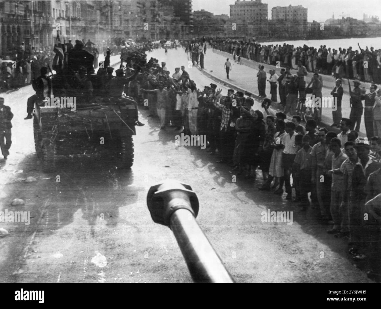Tanks of Fidel Castro's army roll past streets lined with cheering ...