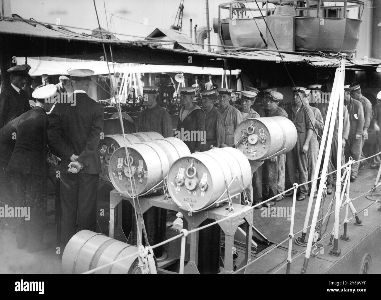 The crew of British destroyer Boadicea lining up before she set sail ...