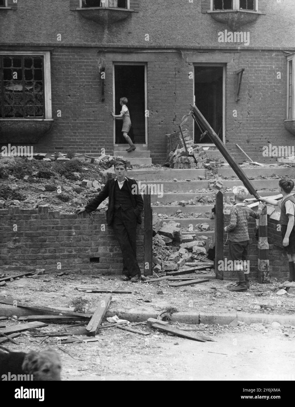 Children inspecting the damage after a bomb fell in Gravesend , Kent ...