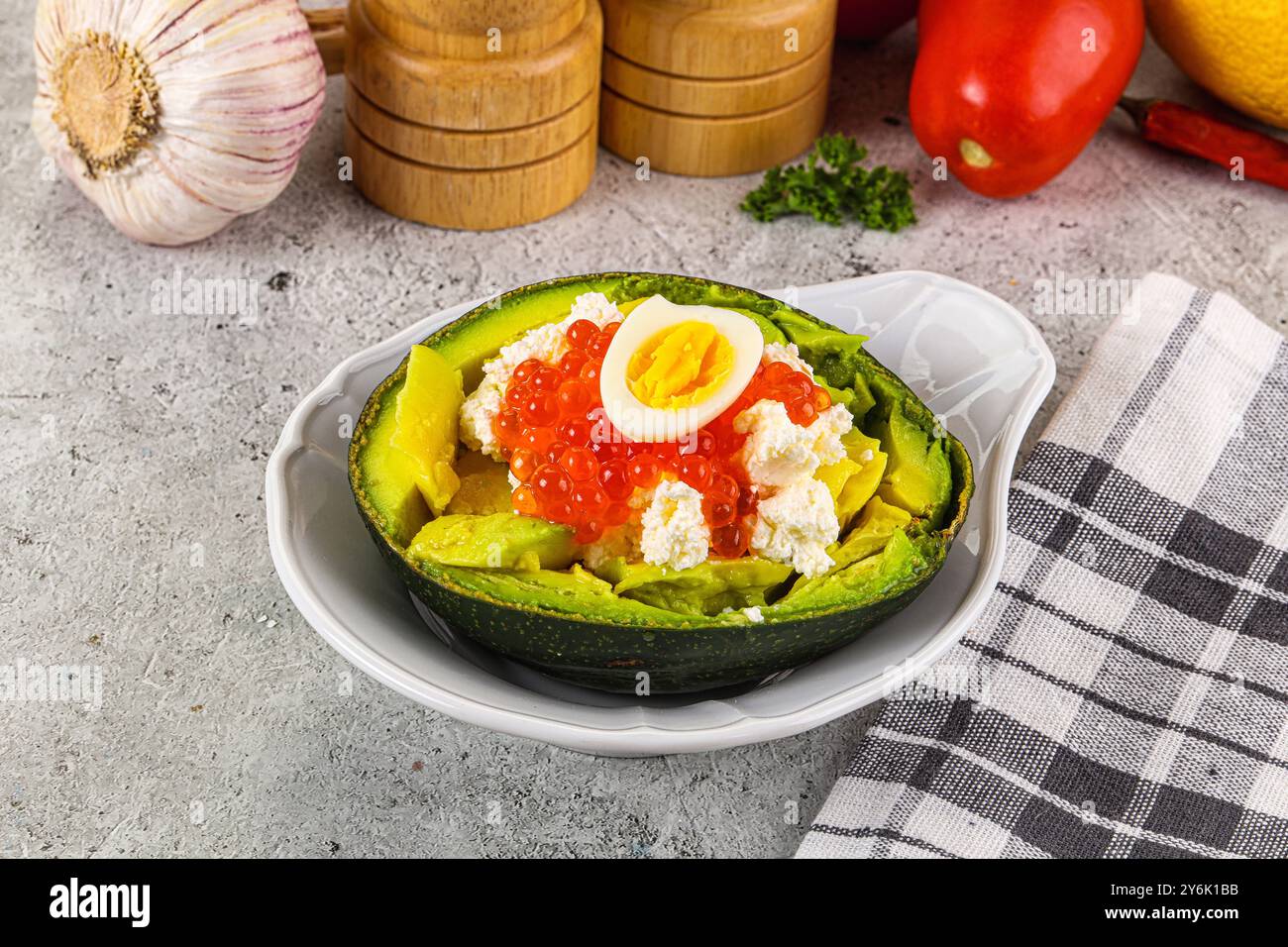 Avocado with red caviar and quil egg and soft cheese Stock Photo - Alamy