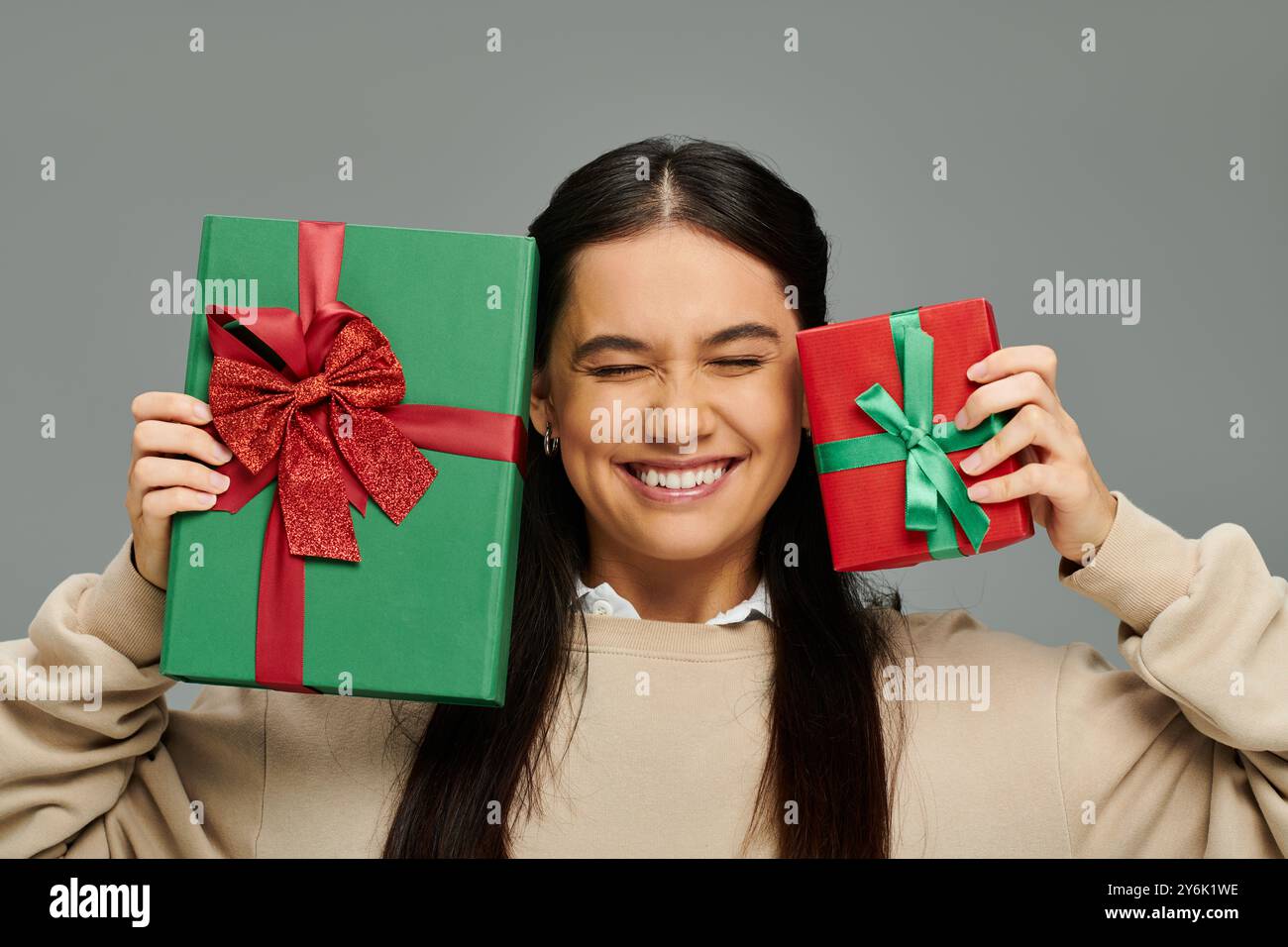 Cheerful young woman beams delight hi-res stock photography and images ...