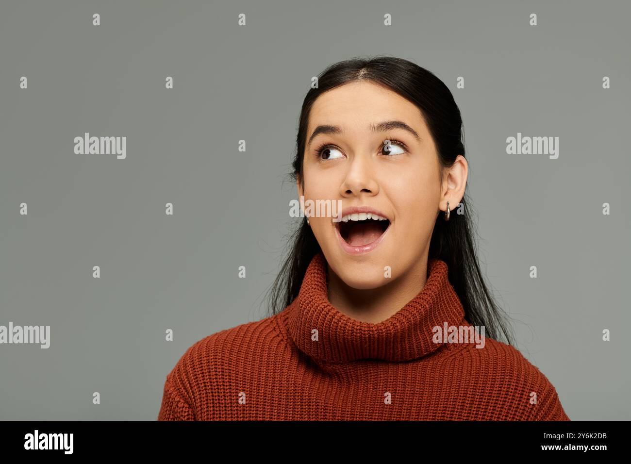 A stylish young woman, filled with emotion, radiates joy in a ...