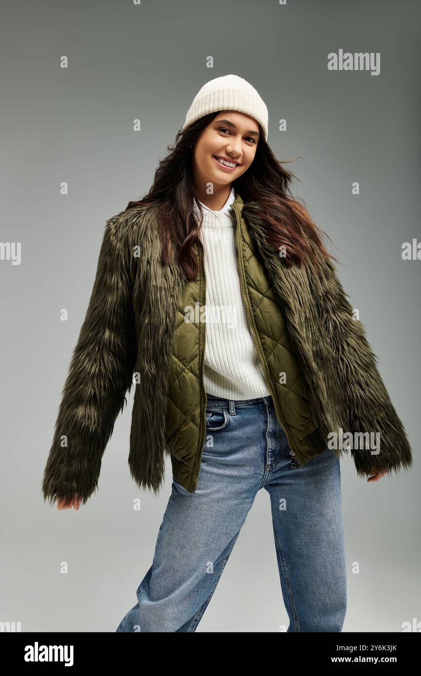 A young woman expresses her emotions while wearing trendy winter ...