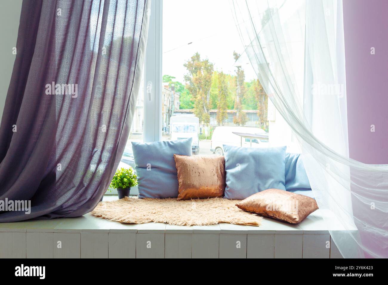cozy window seat with cushions Stock Photo - Alamy