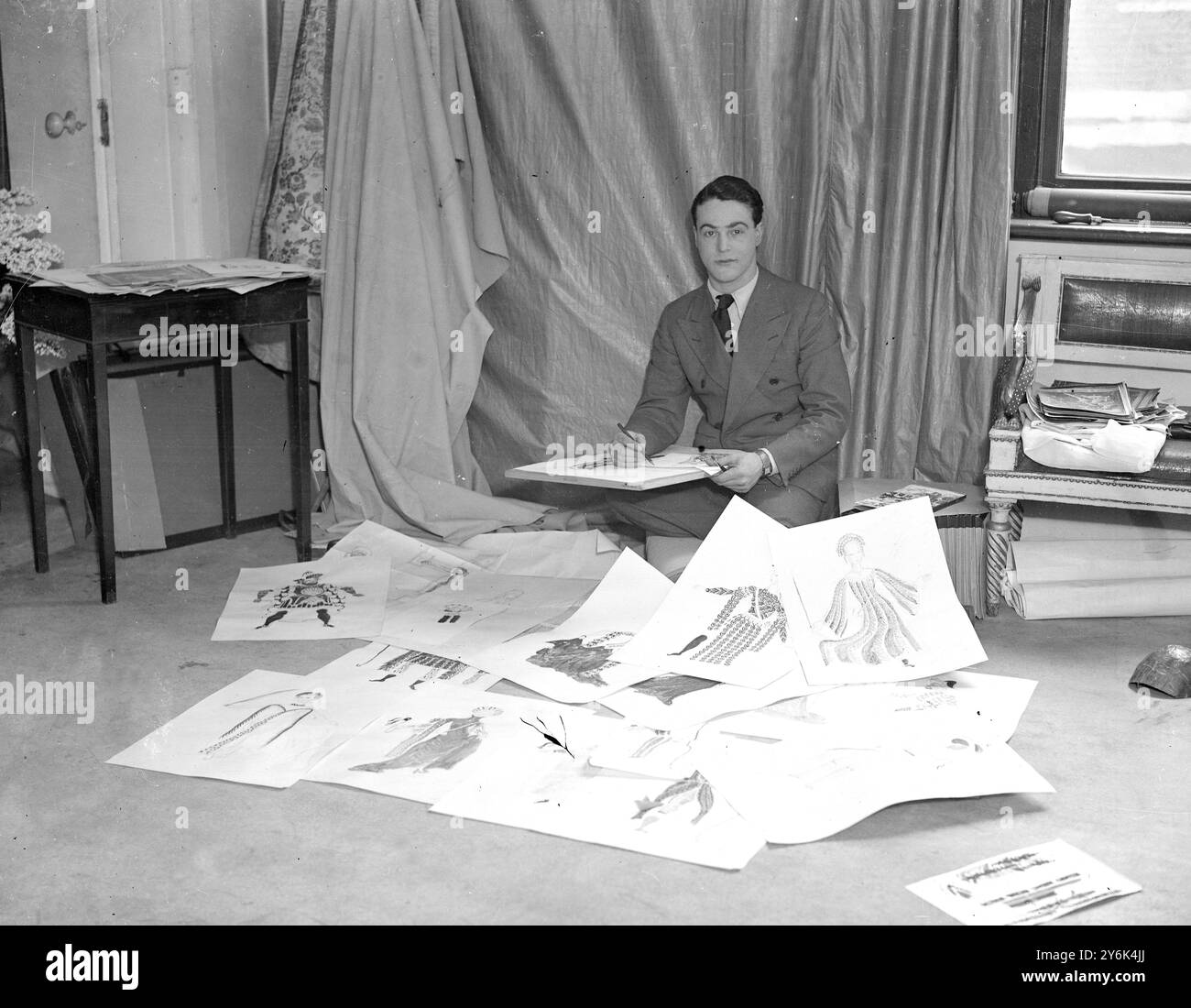 Mr Oliver Messel , who is engaged in designing the costumes for " The Miracle " at work in his ...