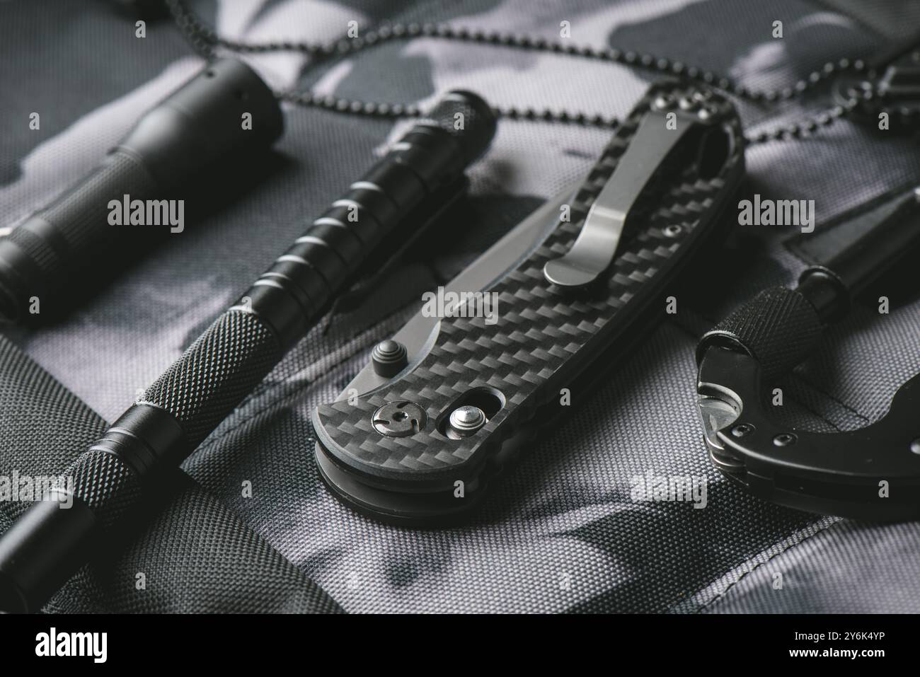 Axis lock system on folding knife with black blade and carbon fiber ...