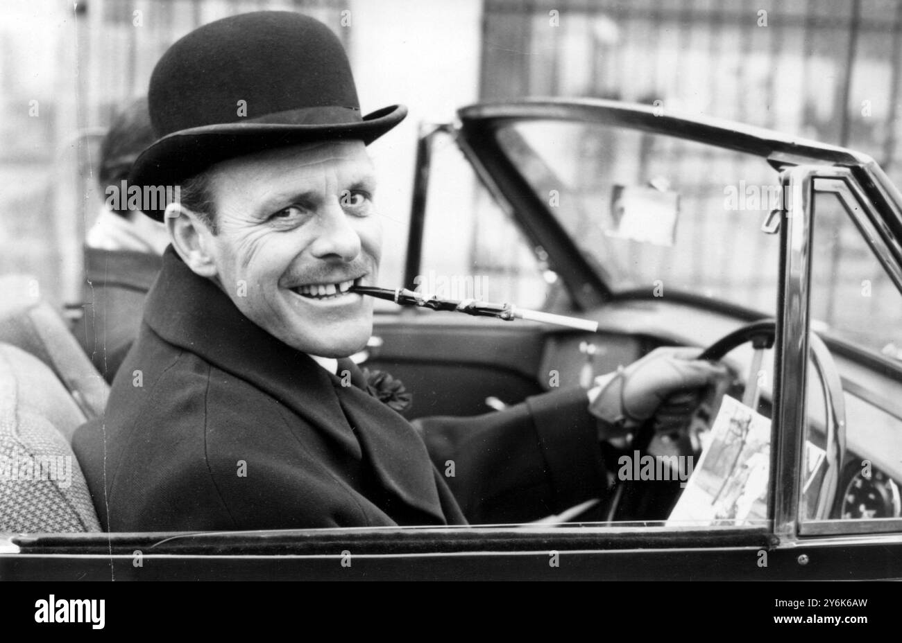 London England Comedian Terry Thomas sitting in a car with cigarette ...
