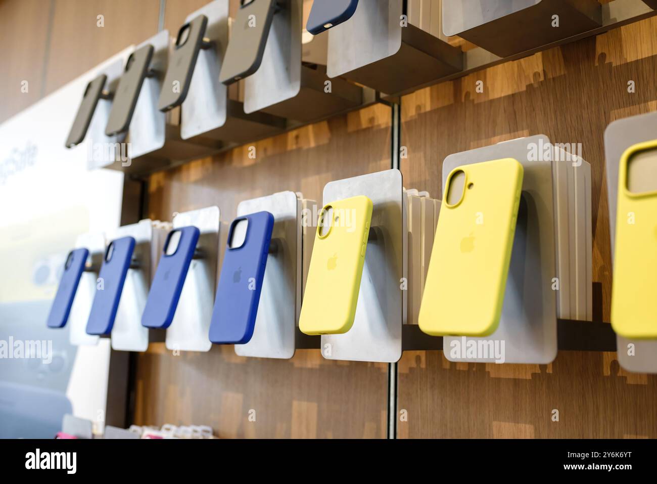 Paris, France - Sep 20, 2024: Blue and yellow iPhone 16 Pro cases on ...