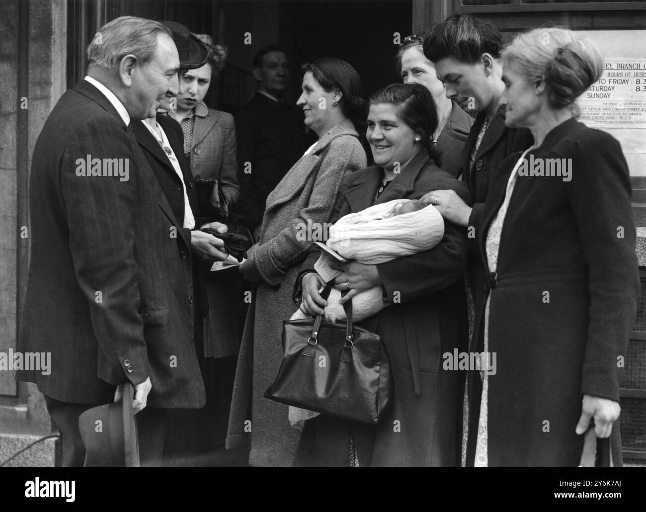 Family Allowances begin. Rt Hon James Griffiths welcoming some of the ...