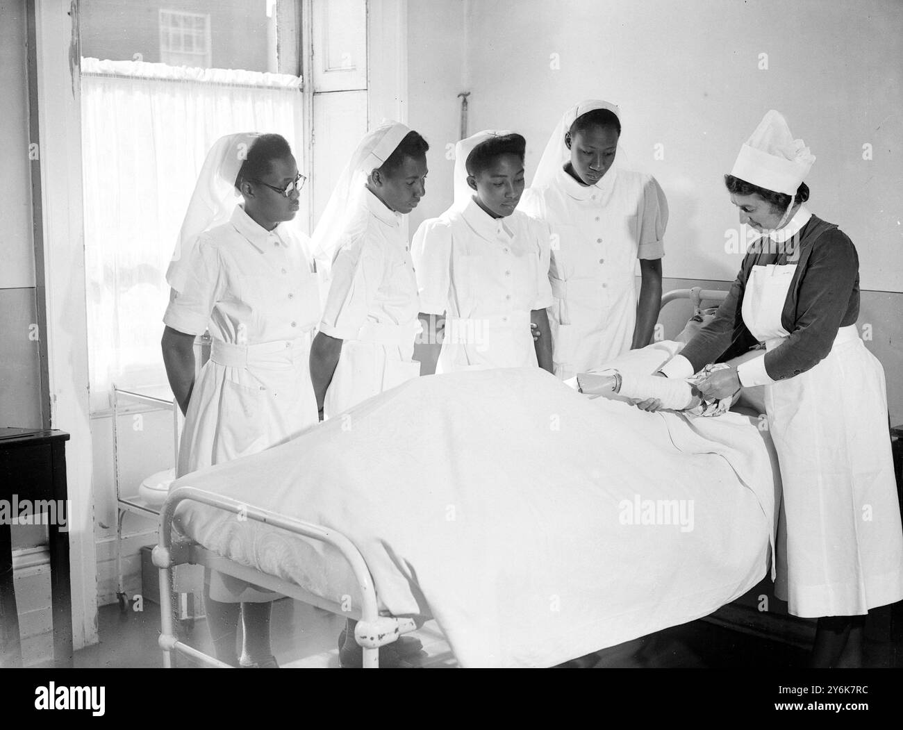 Nigerian student nurses watching a demonstration of dressing by Sister ...
