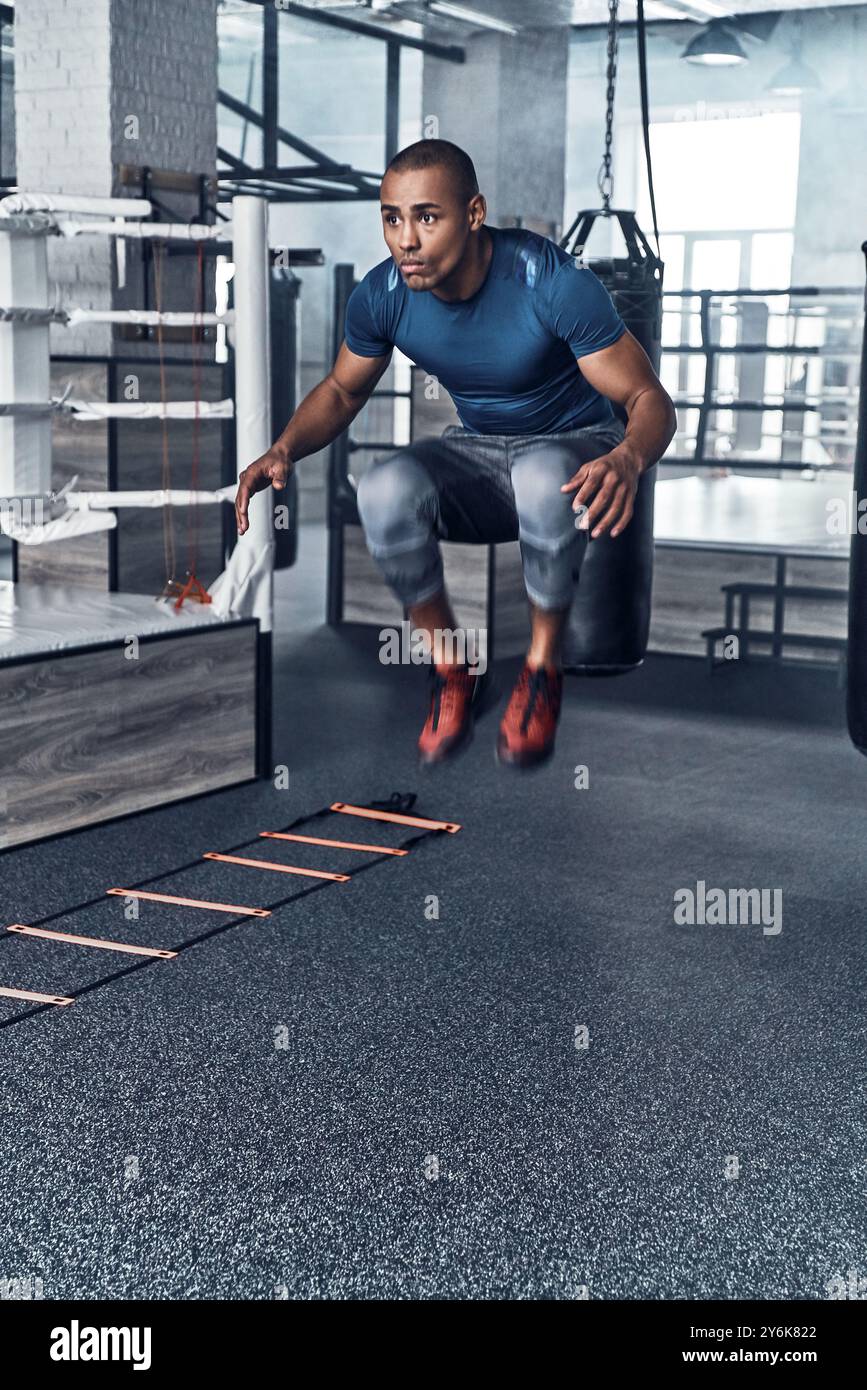 Training like professional. Handsome young African man in sport ...