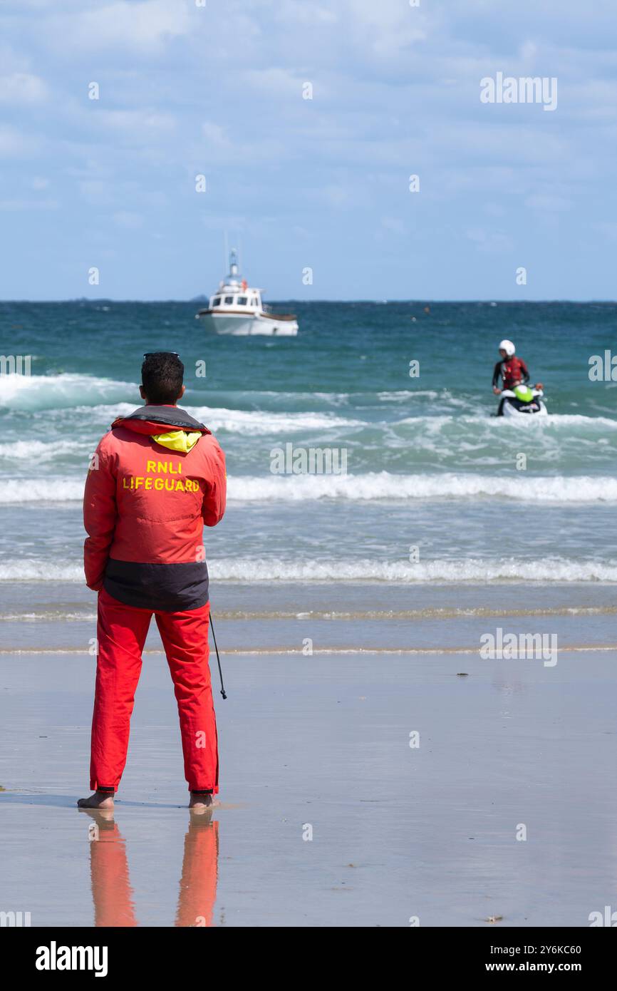 A RNLI Royal National Lifeboat Institution Lifeguard on duty at Towan ...