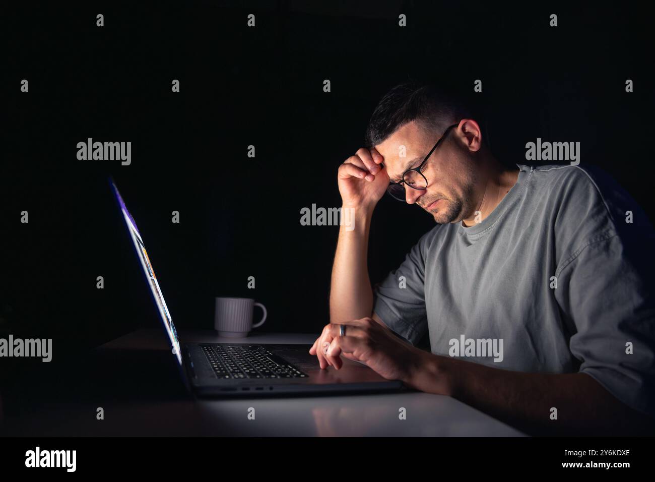Young man works at the computer at night Stock Photo - Alamy