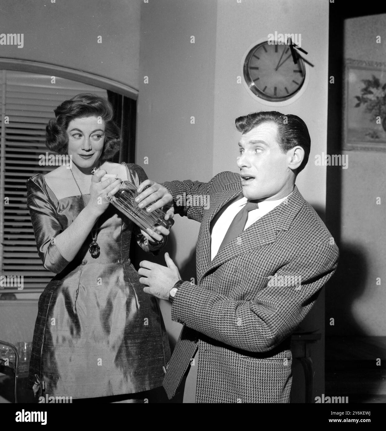 Actress Sarah Churchill gives actor John Gayford a dousing with the ...
