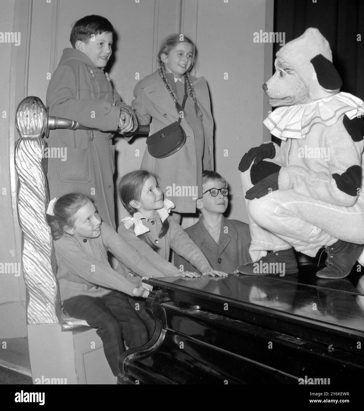 Five children meeting Dog Toby (Deddie Davies) after the show MR PUNCH ...