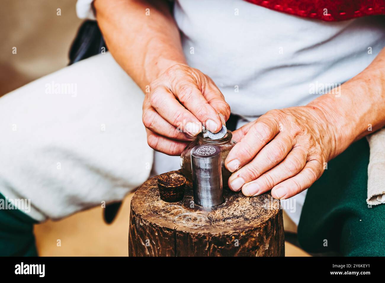 Hand of a craftsman making old fashioned metal coins Stock Photo - Alamy