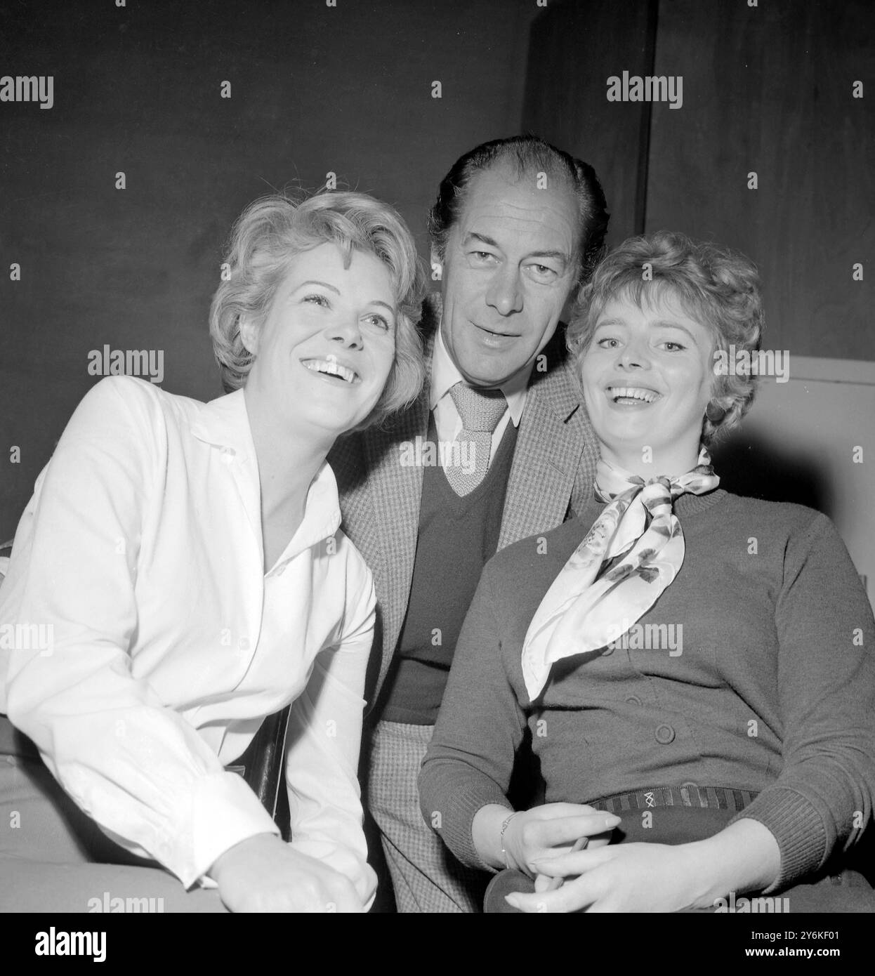 Actor Rex Harrison looks over a script of Chekhov's Platinov with (left ...