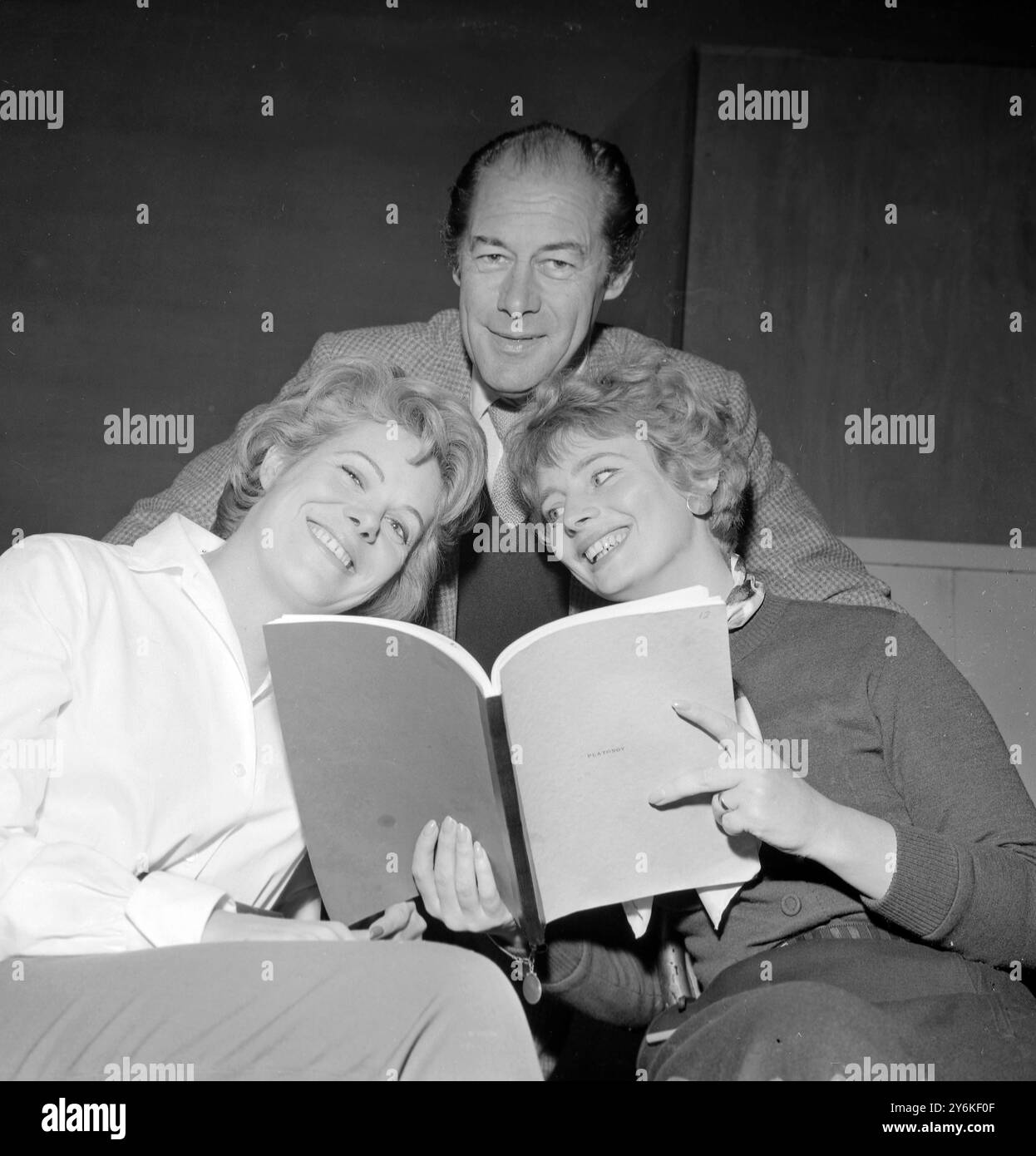 Actor Rex Harrison looks over a script of Chekhov's Platinov with (left ...