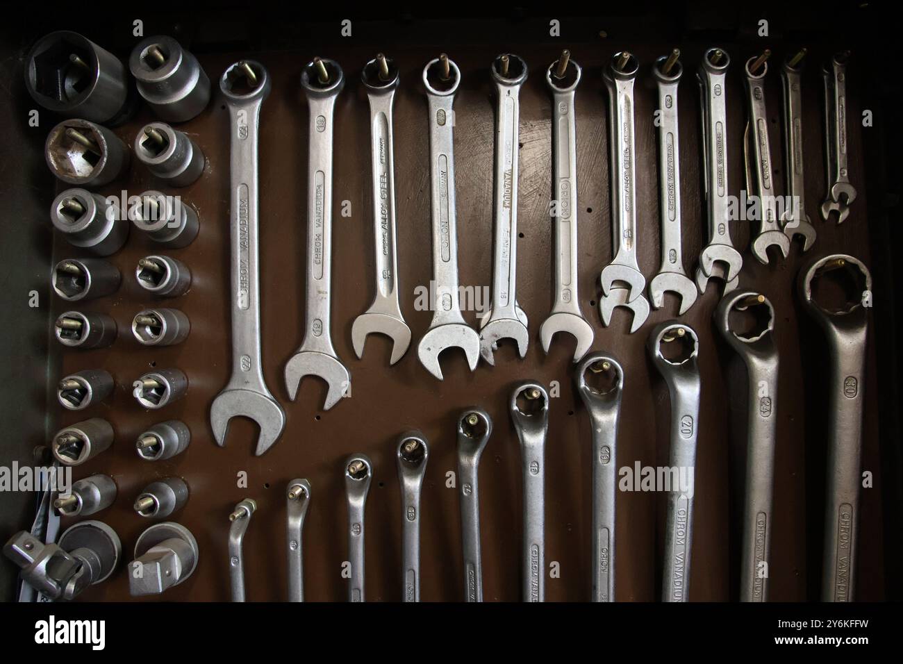 A neatly organized set of wrenches and sockets in a tool drawer ...