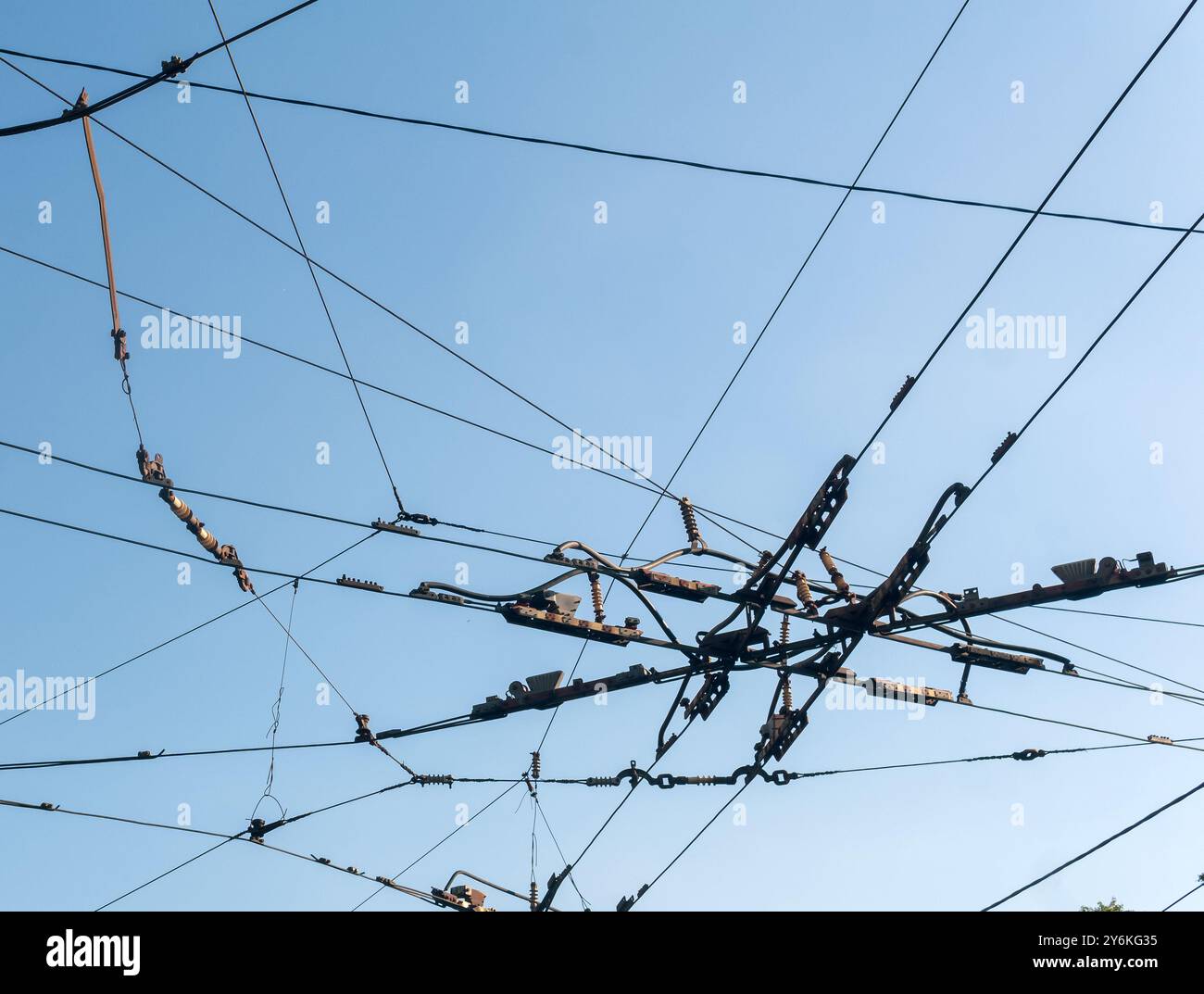 industrial urban background, intertwining cables over the street at the intersection of ...