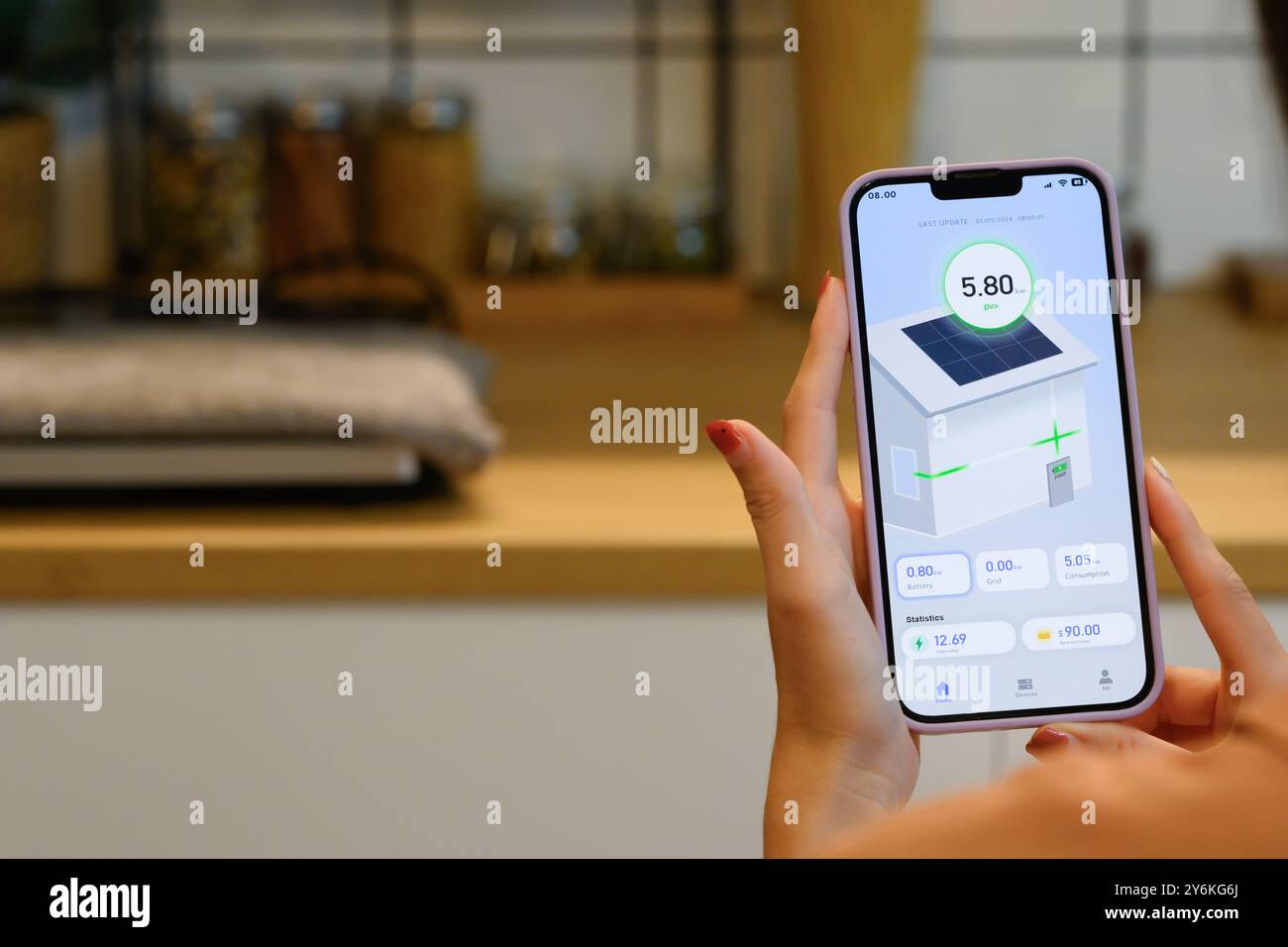 Close up woman monitoring solar panel performance on her smartphone ...