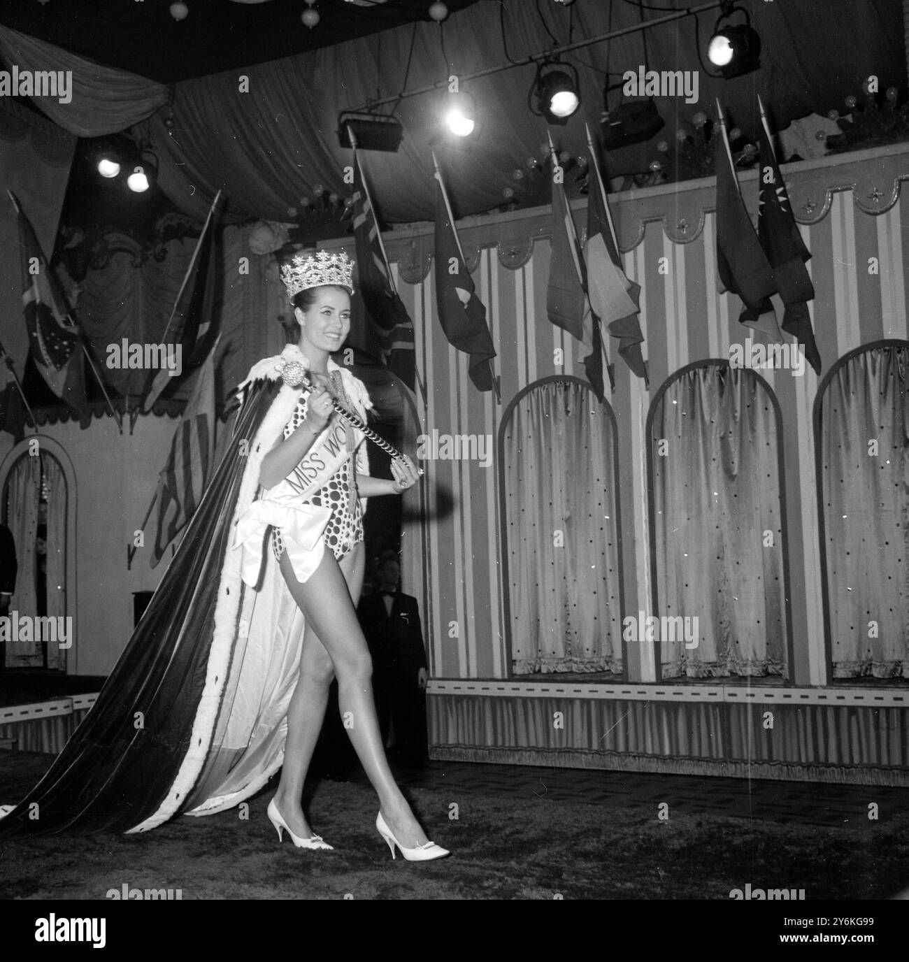 London: Wearing a crown, clock and triumphant smile and carrying a ...