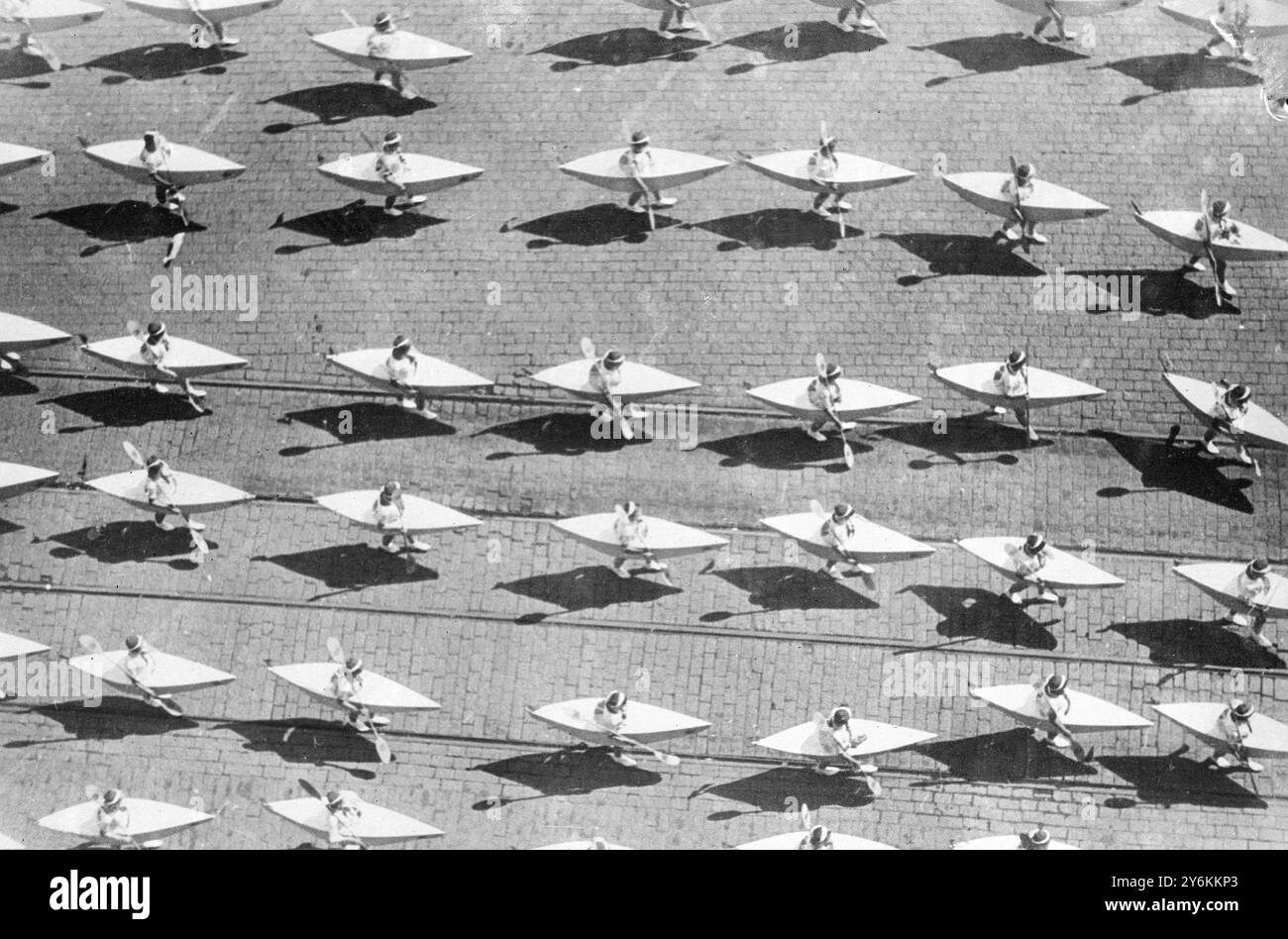 Hundreds of canoeists "wearing" canoes round their waists marched ...