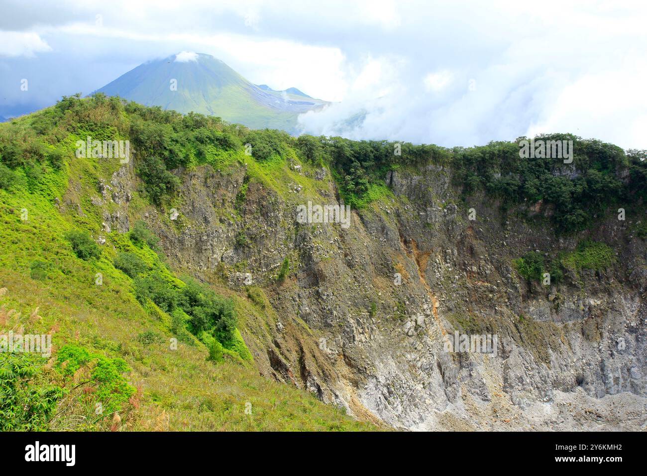 Crater wall at the top of Mount Mahawu with Mount Lokon in the ...