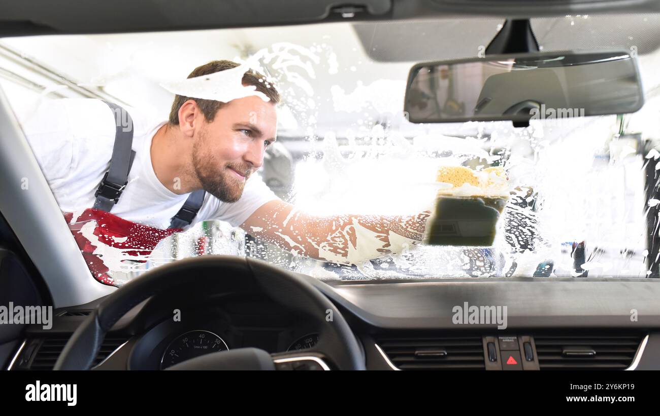 friendly mechanic cleans a car professionel in the car dealership for ...