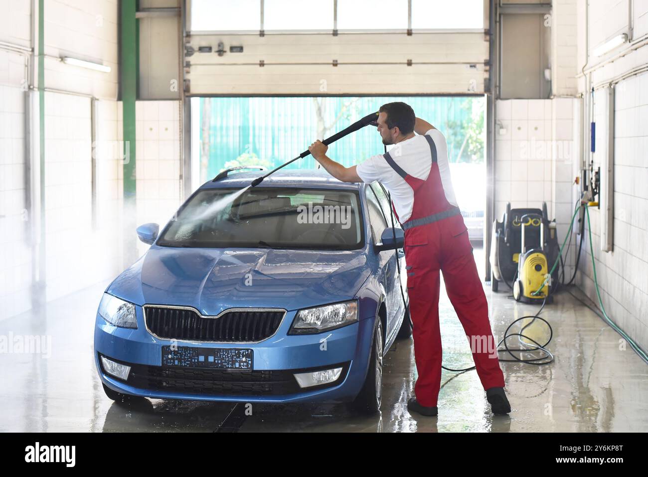 friendly mechanic cleans a car professionel in the dealership for the ...