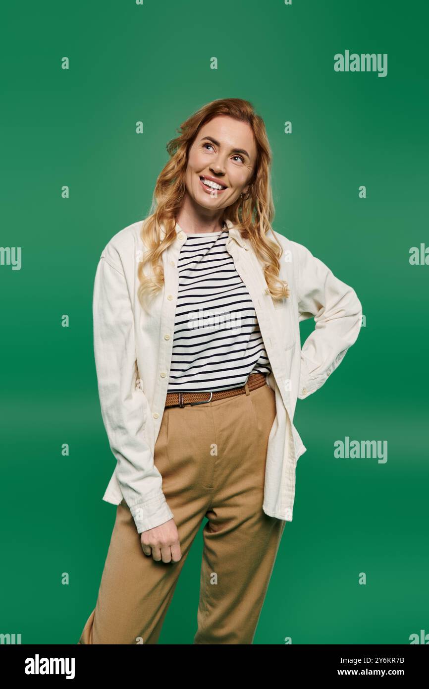 A beautiful woman dressed casually smiles confidently against a bright ...