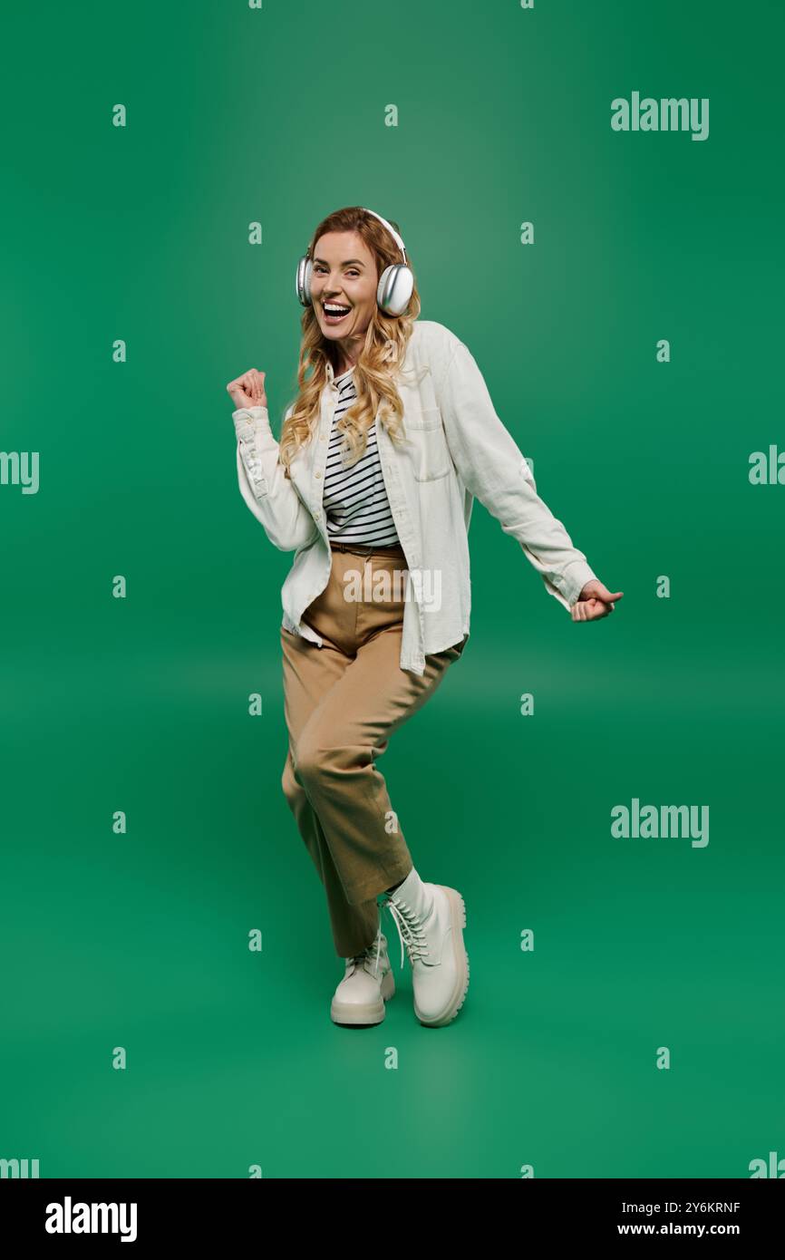 A cheerful woman with curly hair enjoys a lively dance on a bright ...
